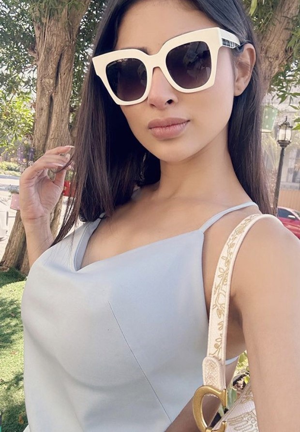 Mouni Roy poses in a pastel-blue dress against a backdrop of azure ...